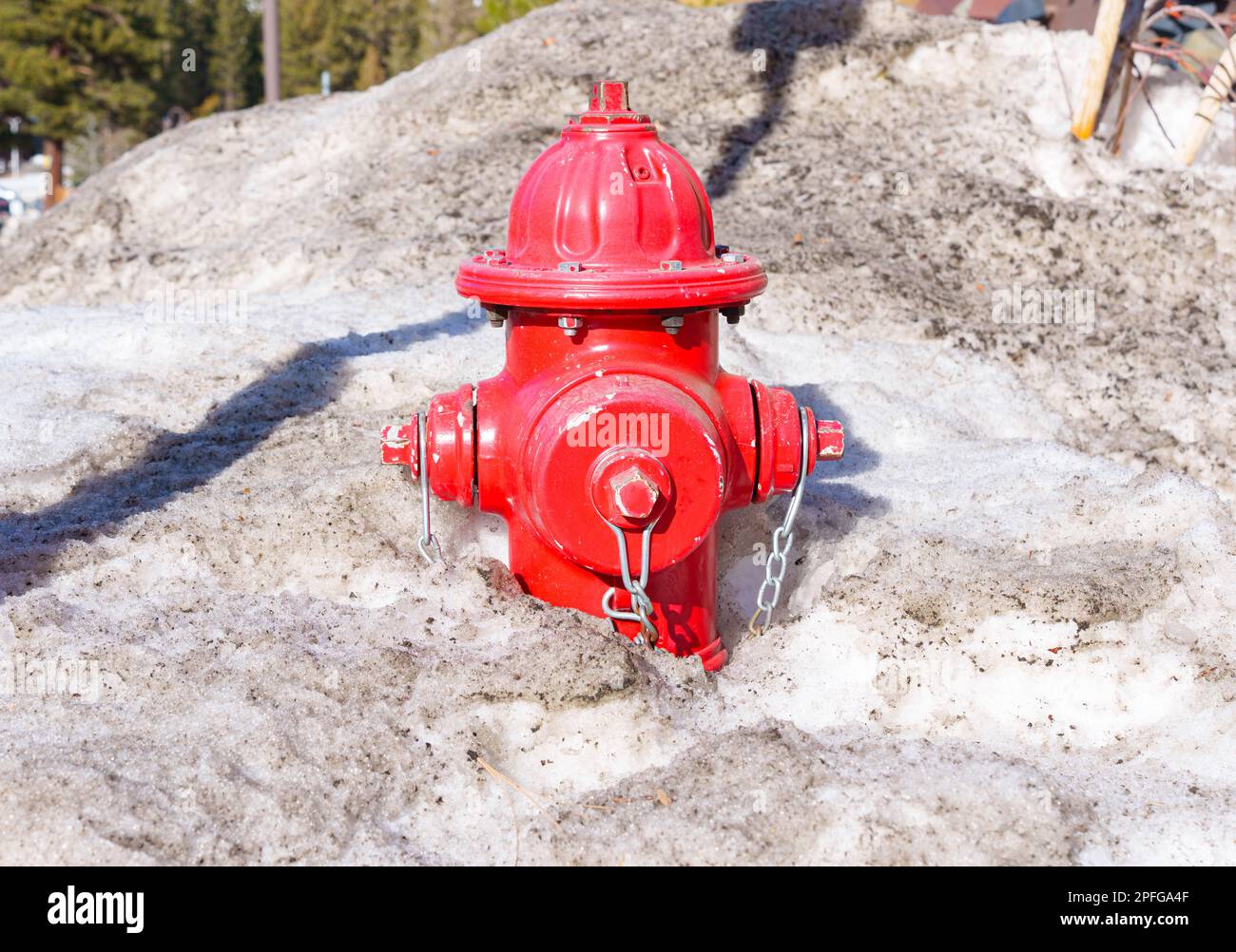 Red fire hydrant covered with dirty snow. Fire safety and snow clearing ...