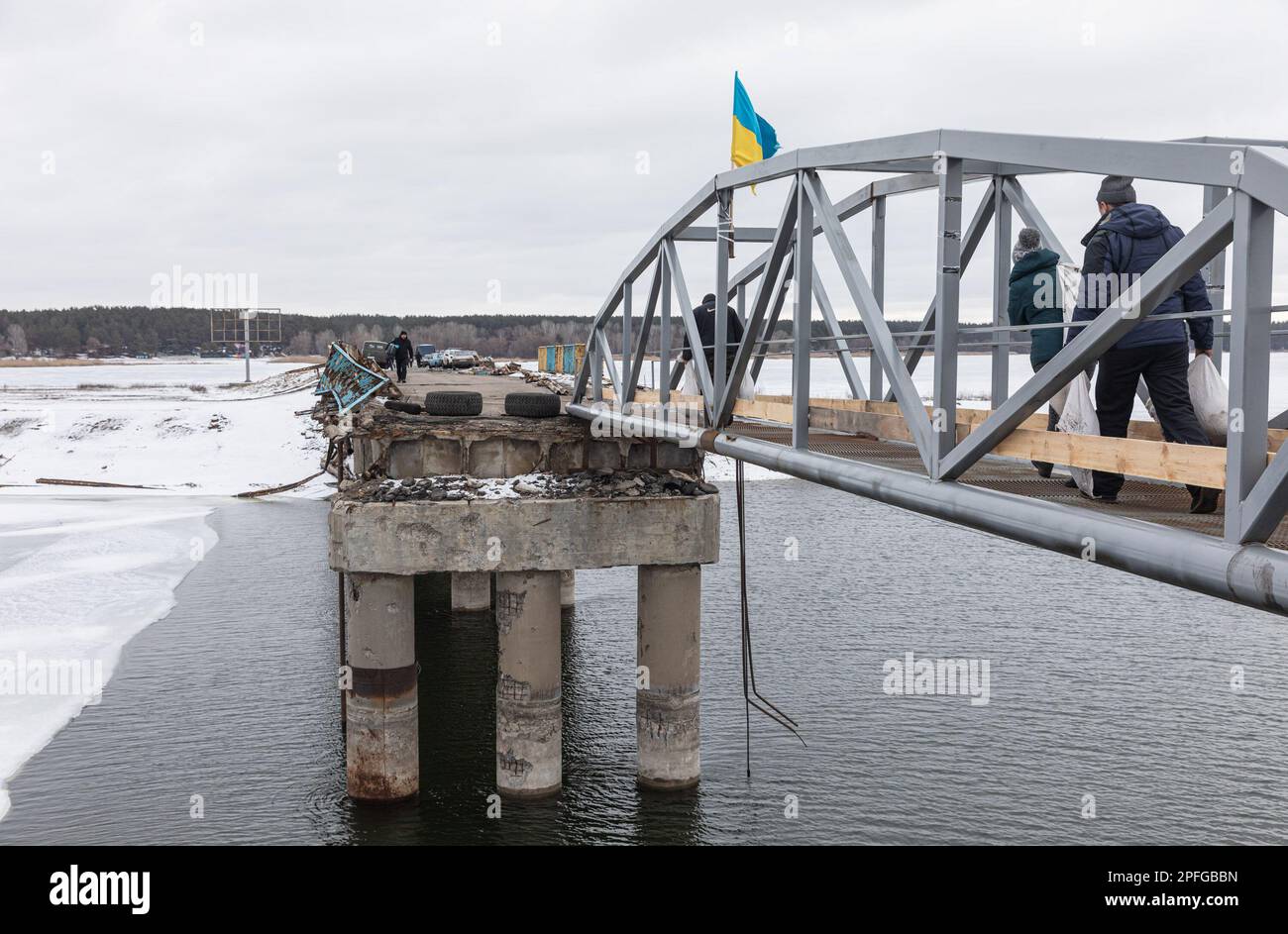 Temporarily restored pedestrian crossing over destroyed bridge across ...
