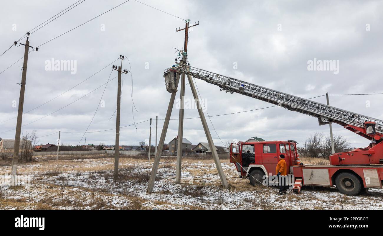 A team of electricians is seen working to restore a power line in ...