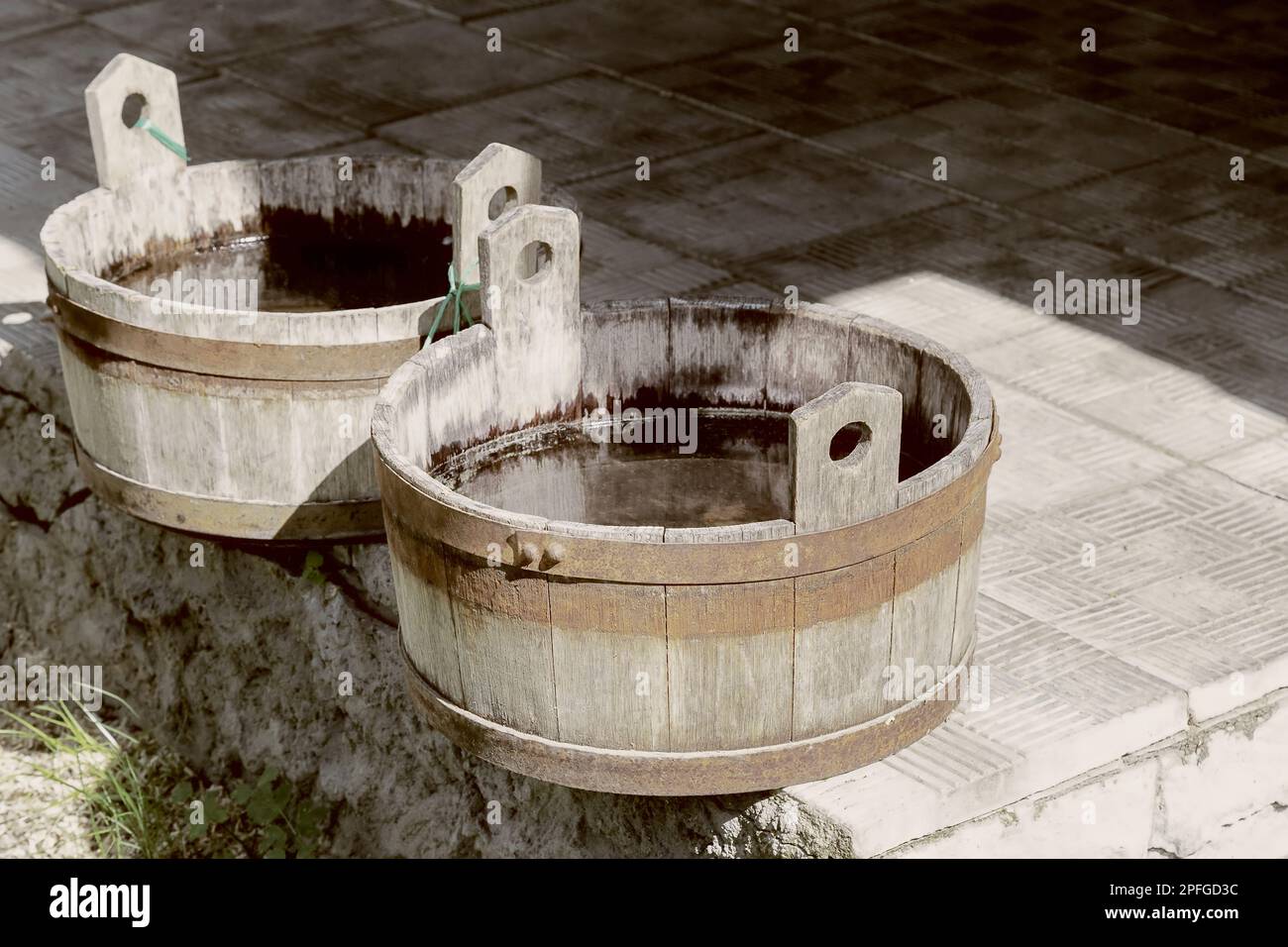 Two antique water vats made of oak planks, fastened together with an ...