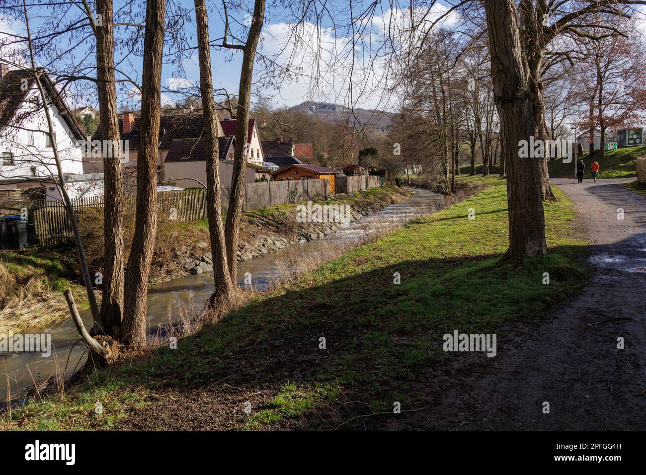 The little river Oechse flows past gardens, trees and meadows in the ...