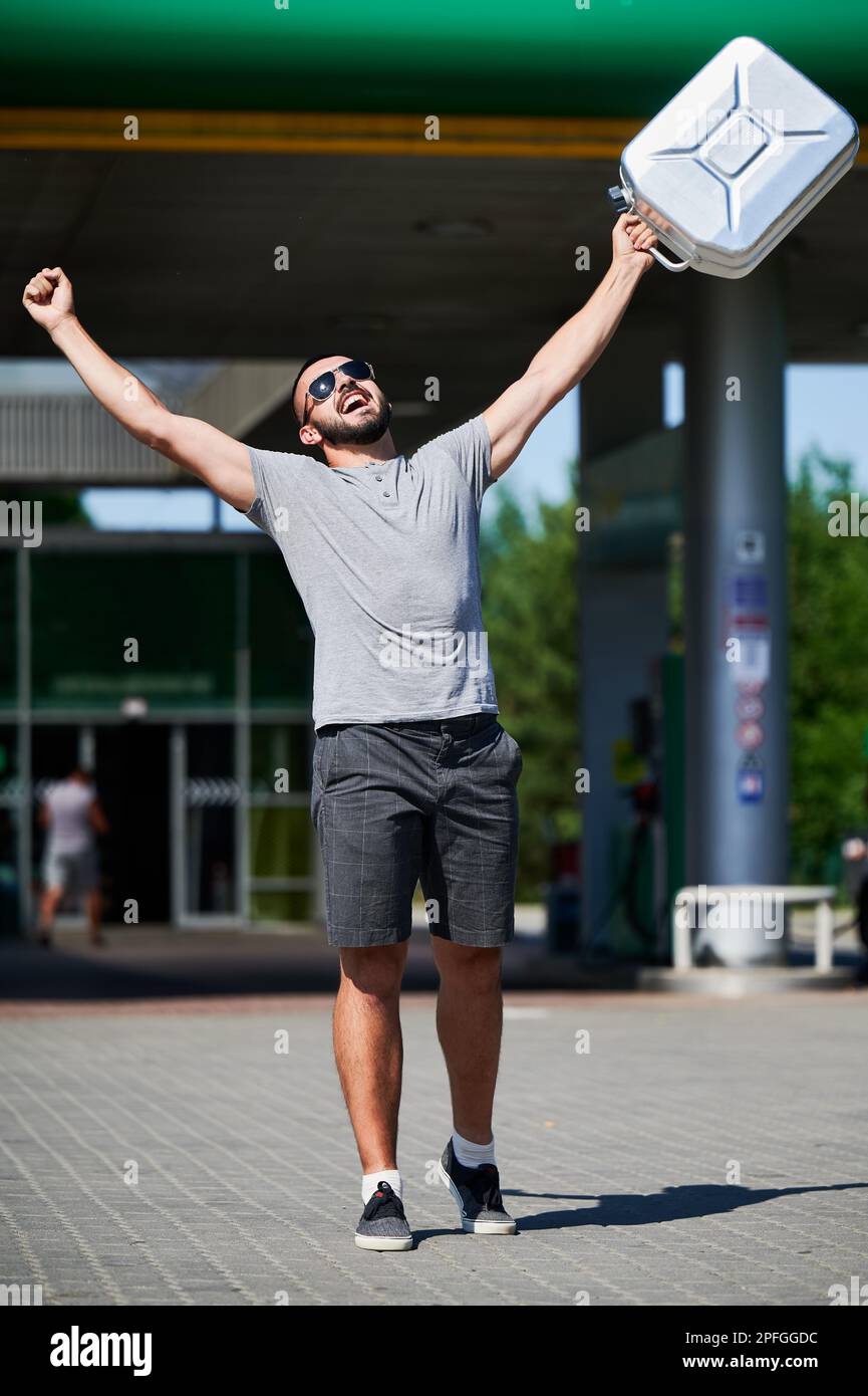Happy man finally got to gas station to fill tank with fuel. Man glad ...