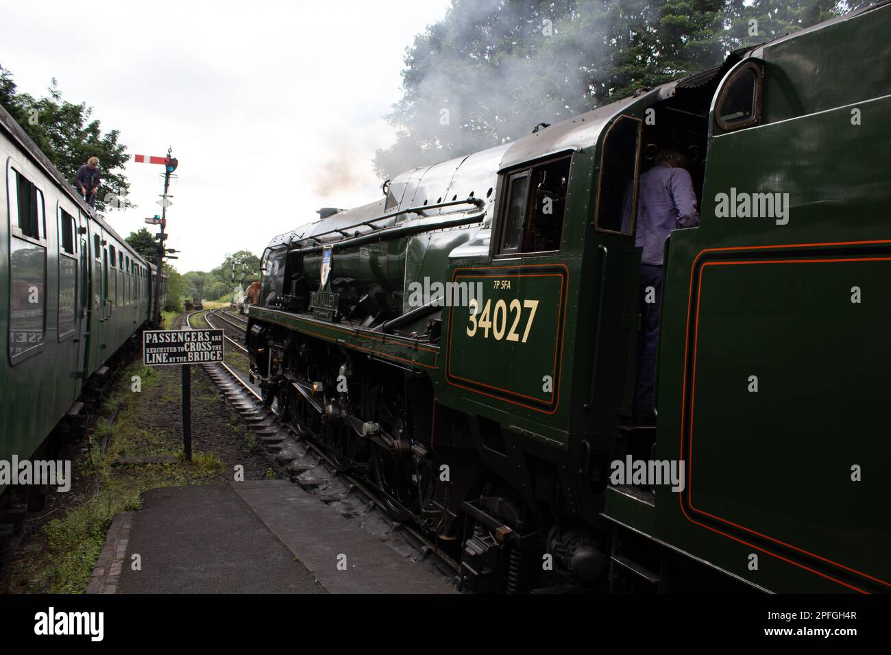 Steam locomotive pulling out from the platform Stock Photo - Alamy