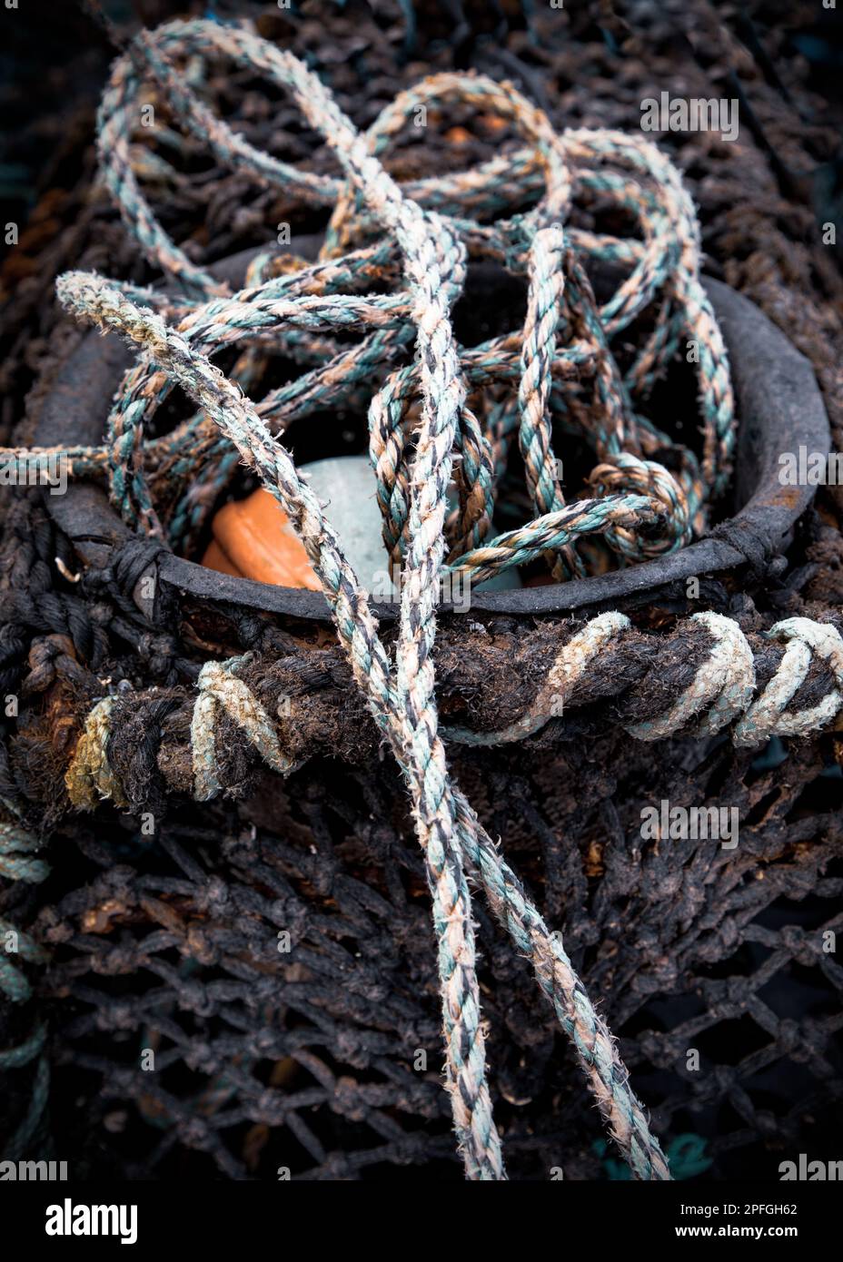 A pile of old crab traps and fishing nets stacked on one another Stock ...
