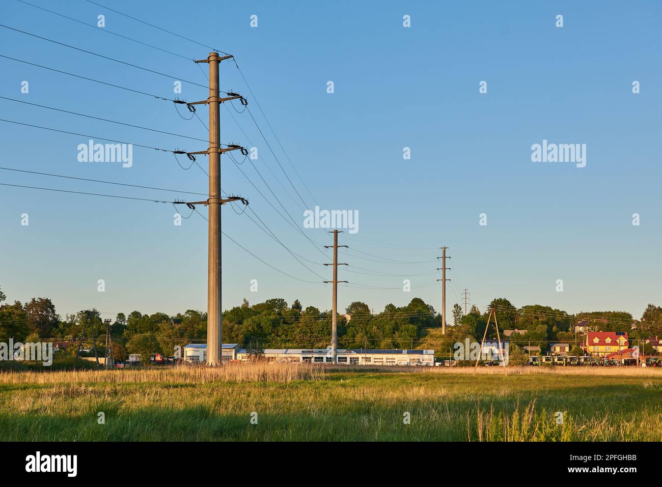Overhead high voltage power line, on metal poles Stock Photo - Alamy