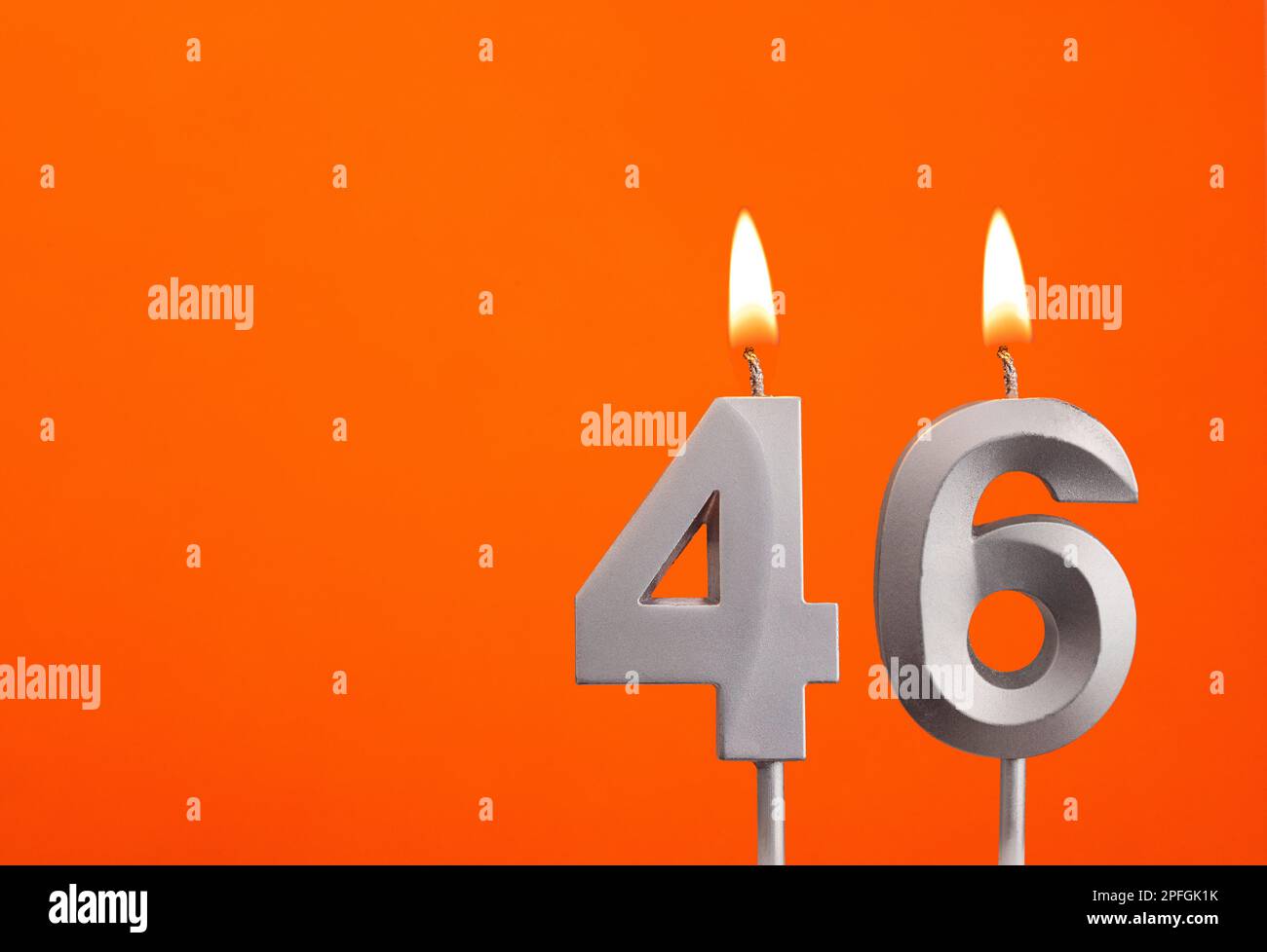 Candle number 46 - Birthday in orange background Stock Photo - Alamy