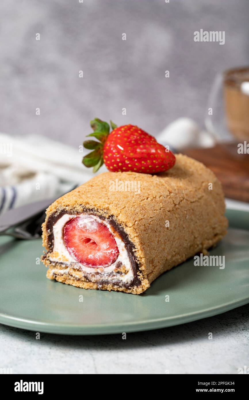 Rolled log cake. Strawberry and cream cake on a stone background ...