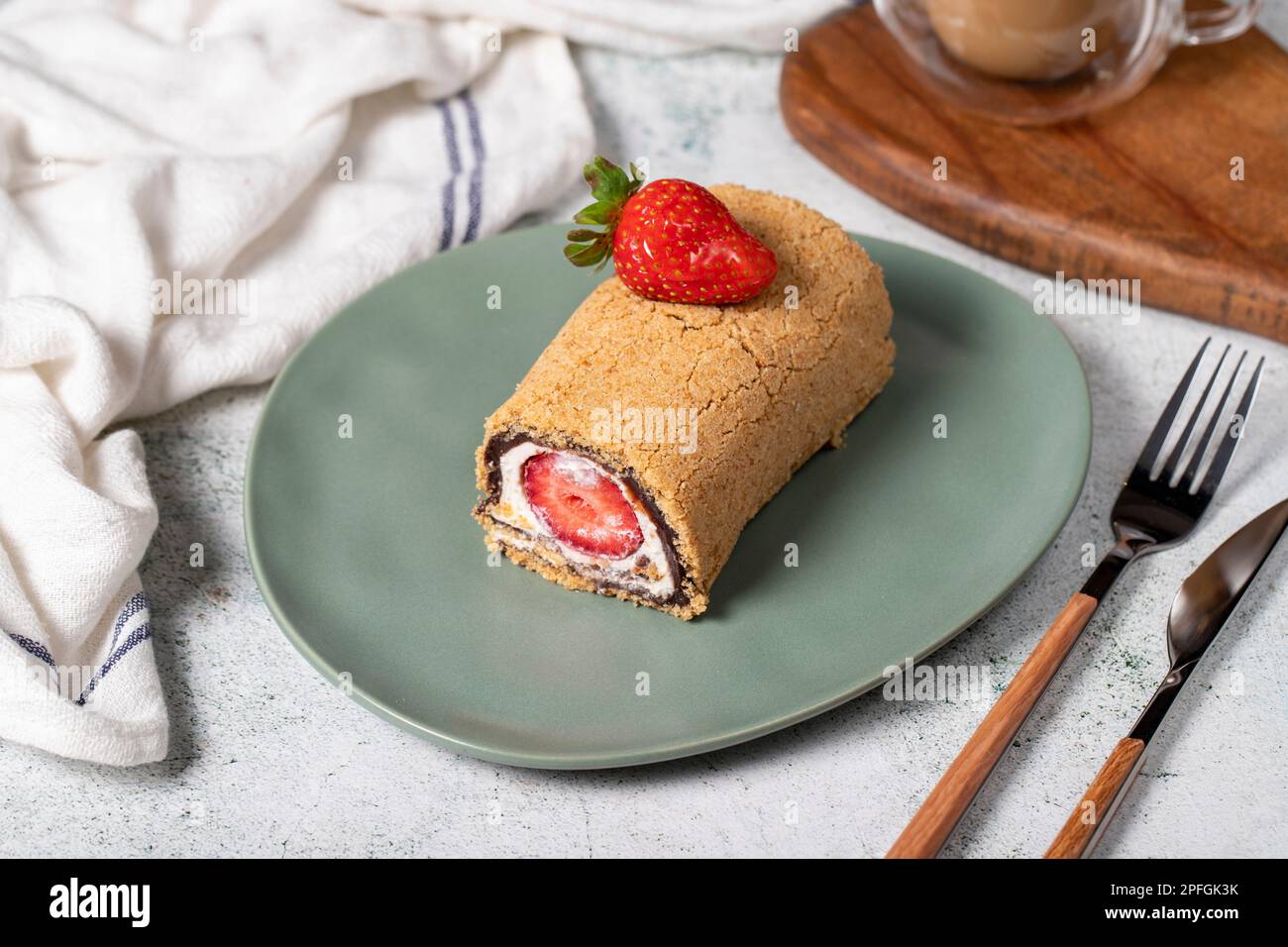 Rolled log cake. Strawberry and cream cake on a stone background ...