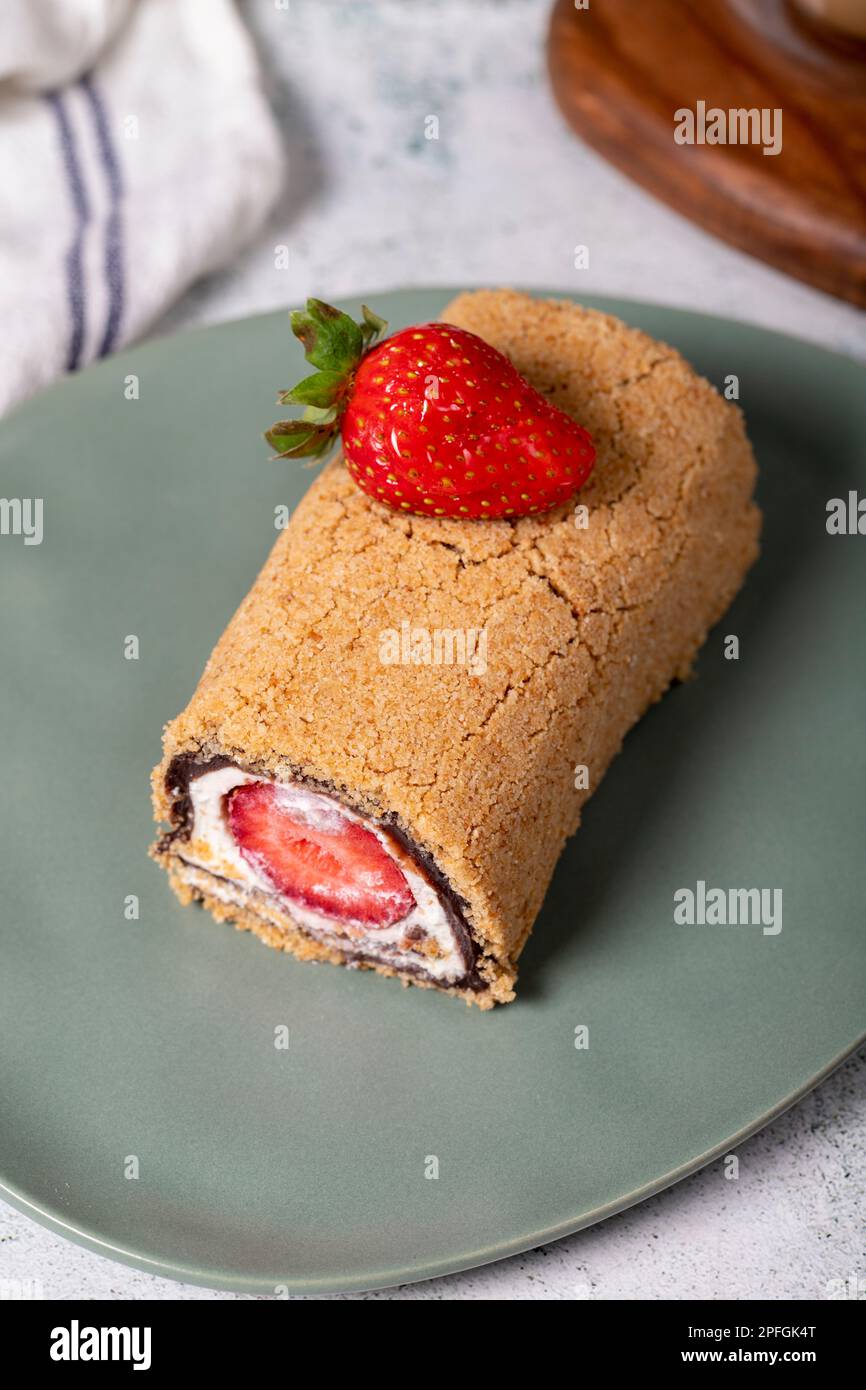 Rolled log cake. Strawberry and cream cake on a stone background ...