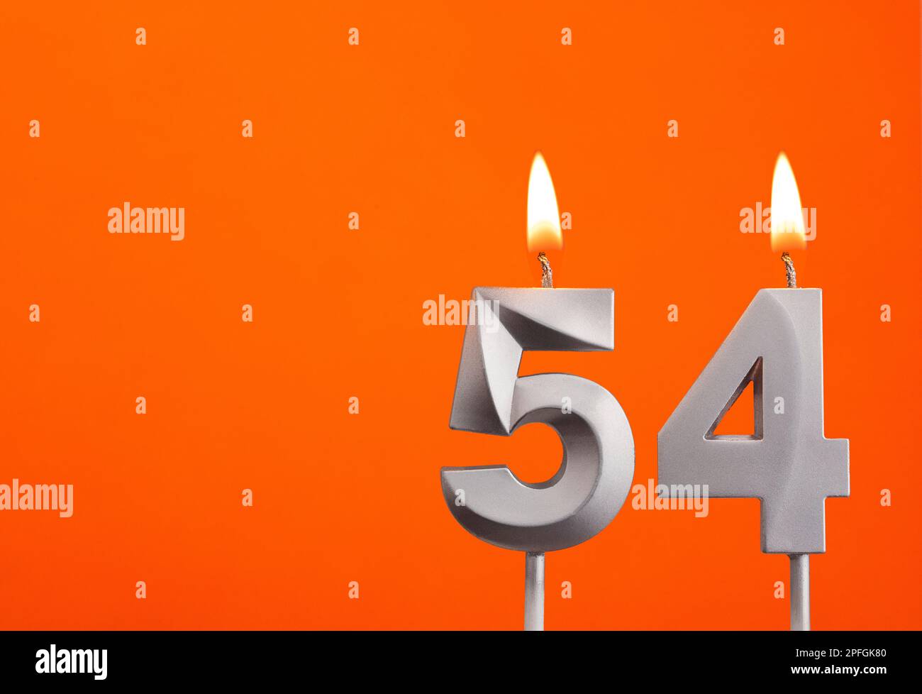 Candle number 54 - Birthday in orange background Stock Photo - Alamy