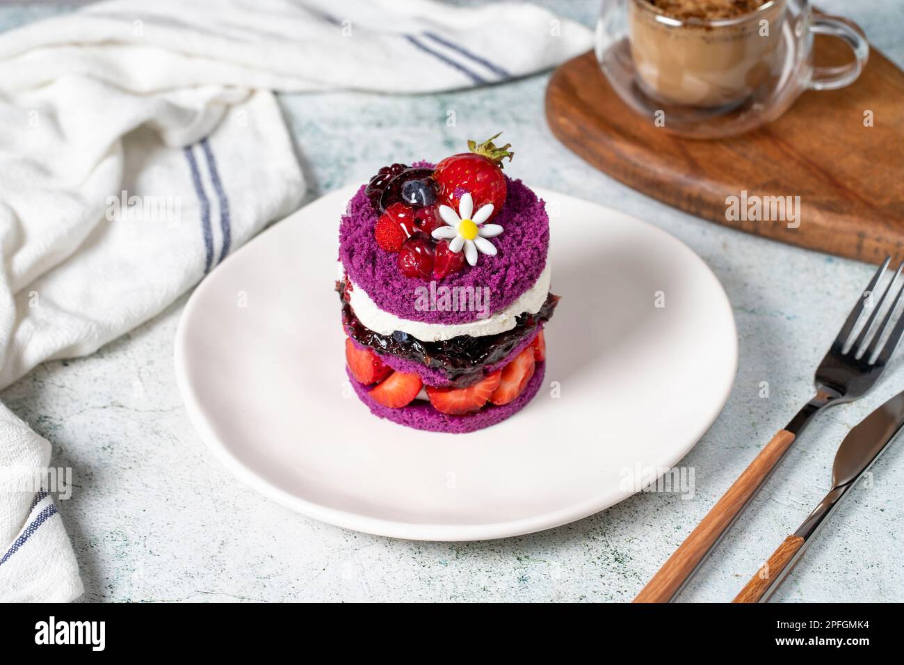 Layered fruit cake. Cake with strawberries, raspberry sauce and cream ...