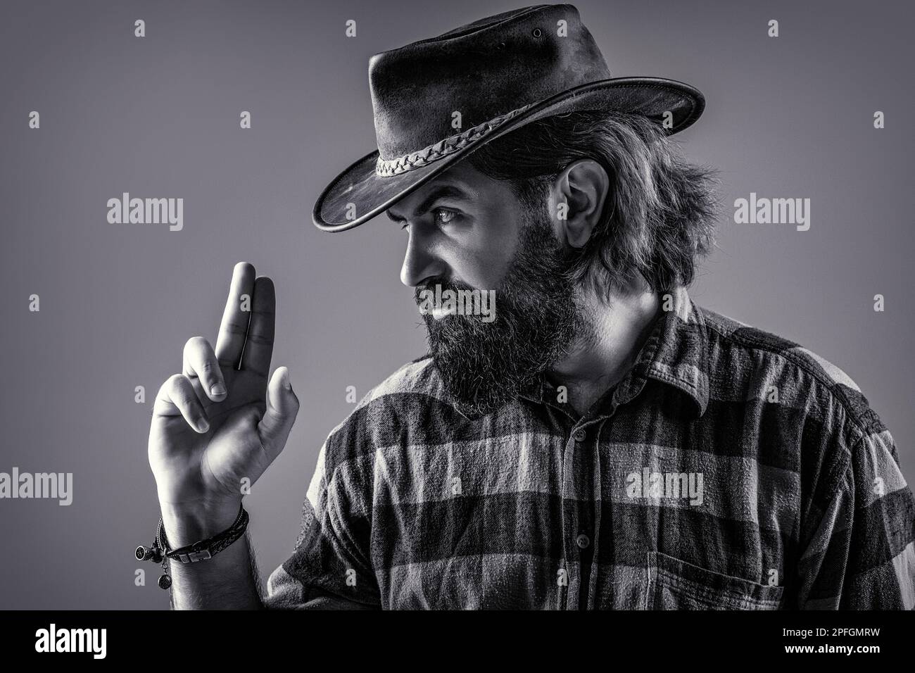 West, guns. Portrait of a cowboy. Portrait of cowboy in hat. Portrait ...