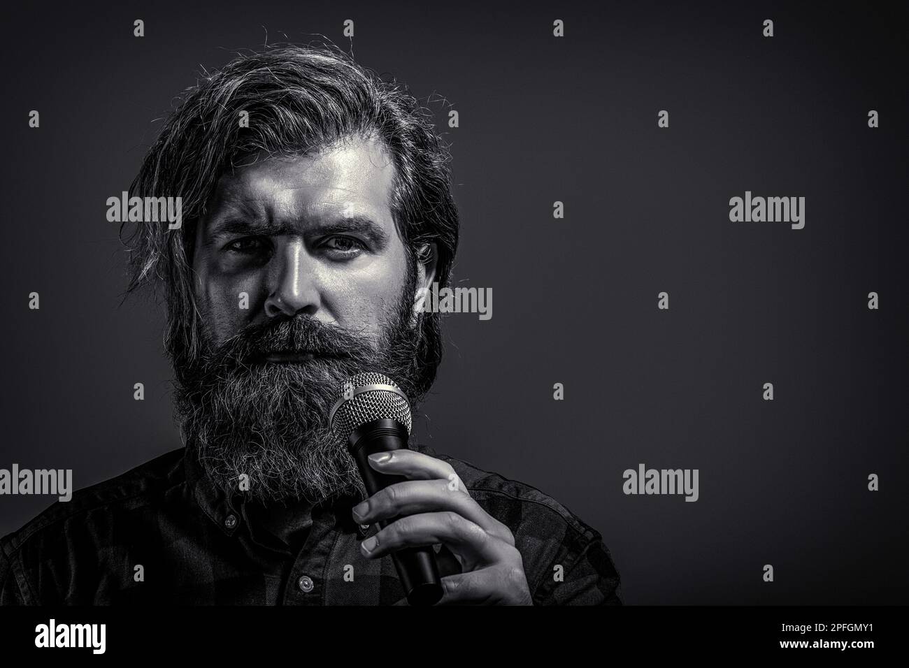Bearded man singing with microphone. Male singing with a microphones ...
