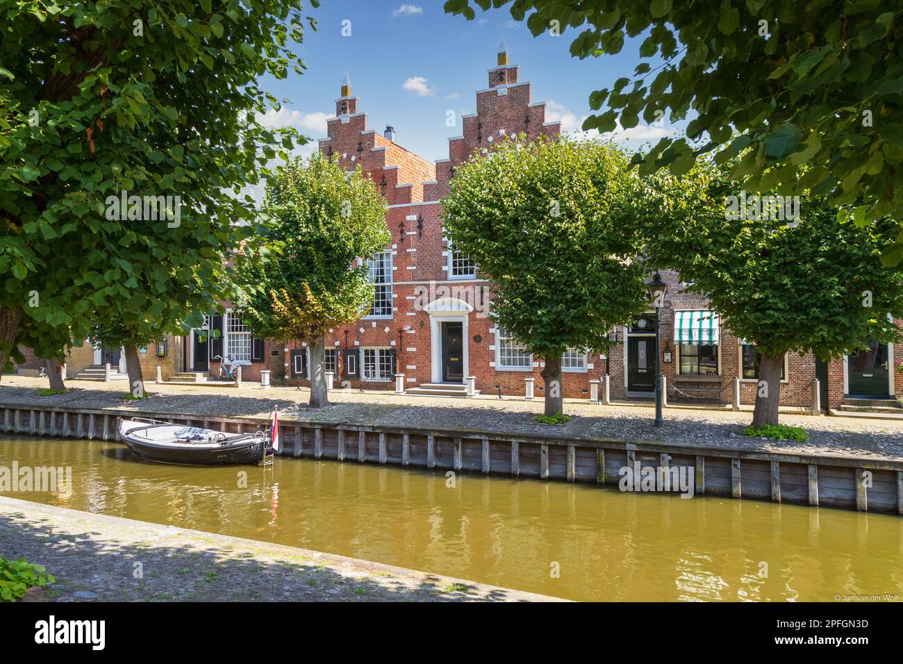 Picturesque houses along the canal in the fortified town of Sloten in ...