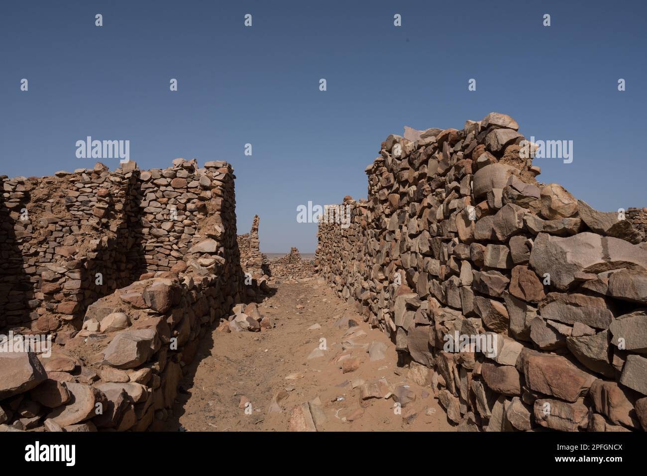 The crumbling stone walls and ruins of the ancient desert city of ...