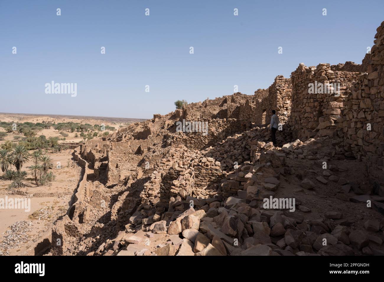 The crumbling stone walls and ruins of the ancient desert city of ...