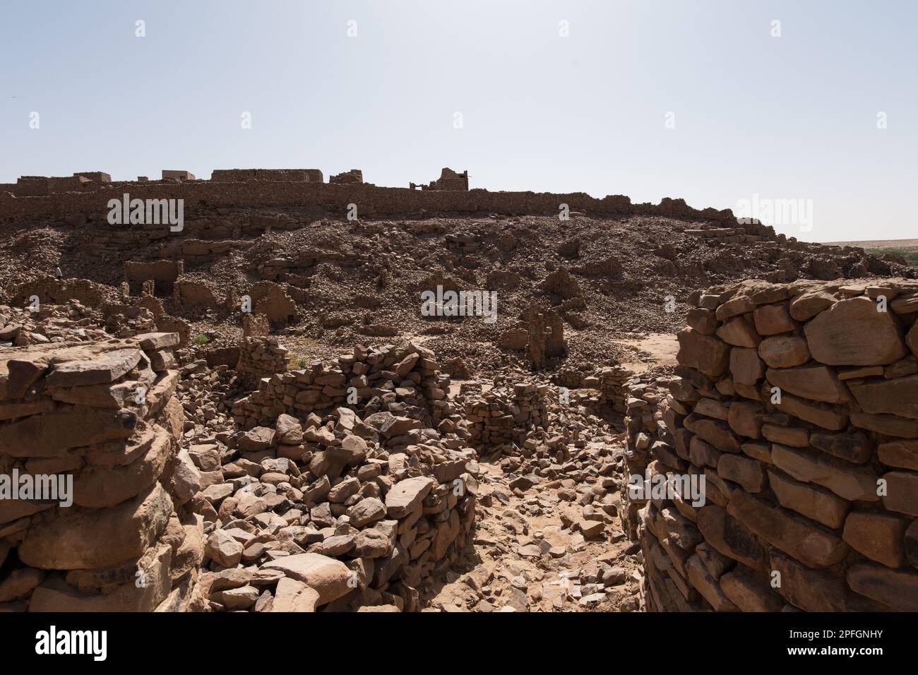 The crumbling stone walls and ruins of the ancient desert city of ...