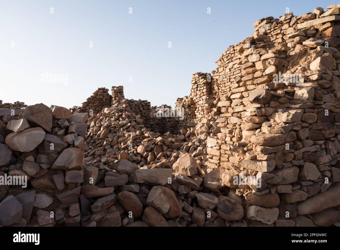 The crumbling stone walls and ruins of the ancient desert city of ...
