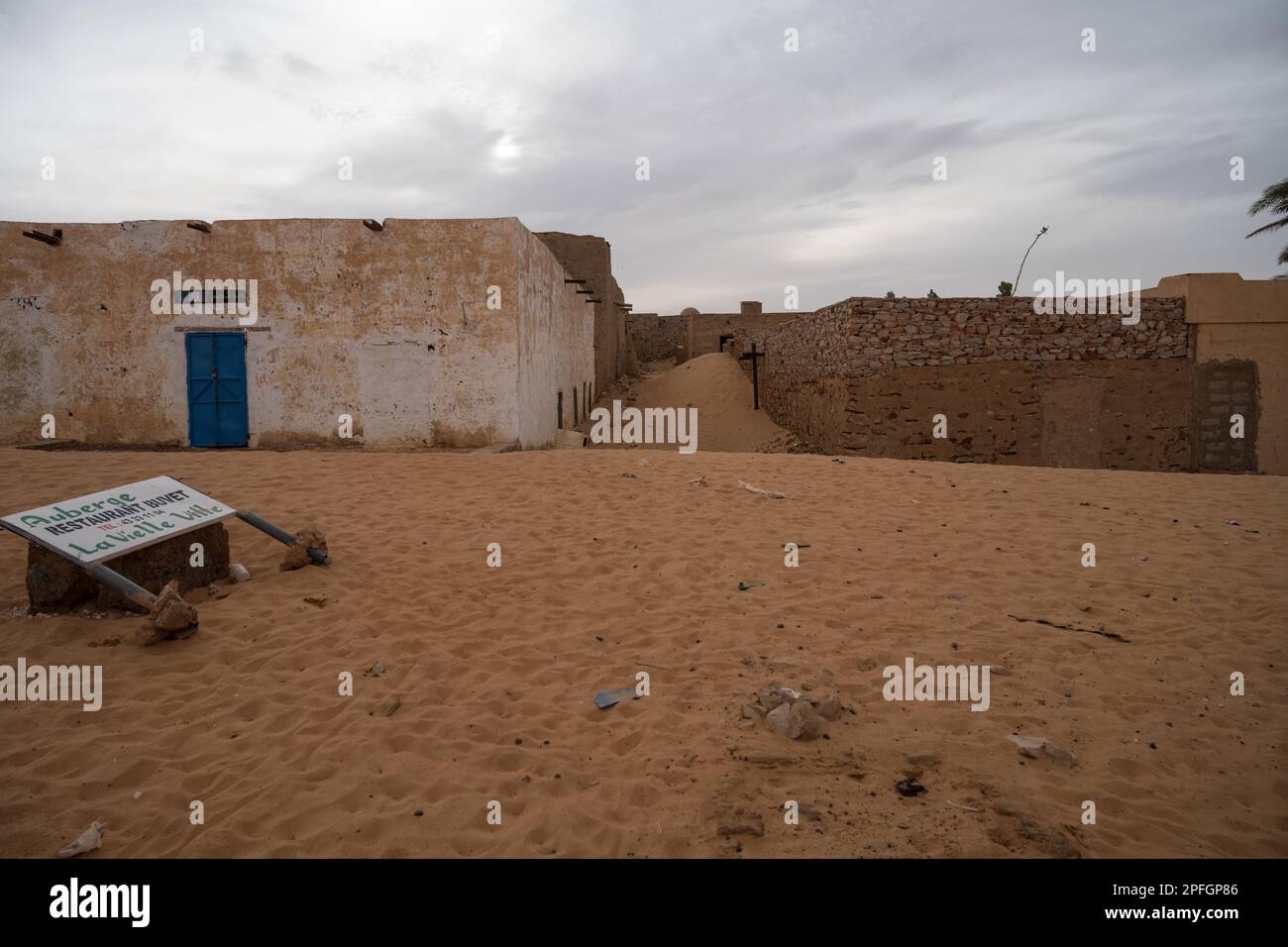 A narrow street in the ancient city of Chinguetti, Mauritania, lined ...