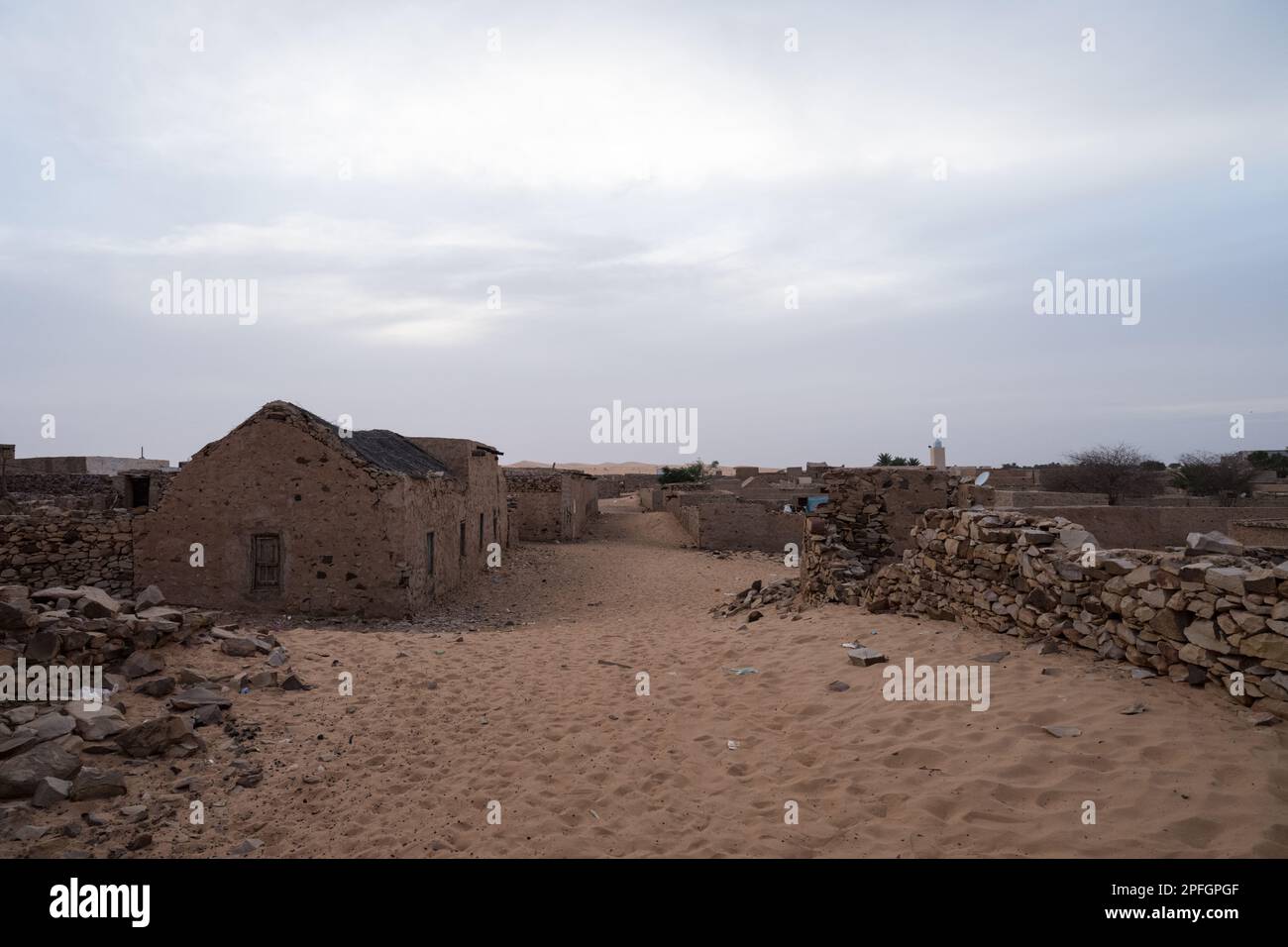 A narrow street in the ancient city of Chinguetti, Mauritania, lined ...
