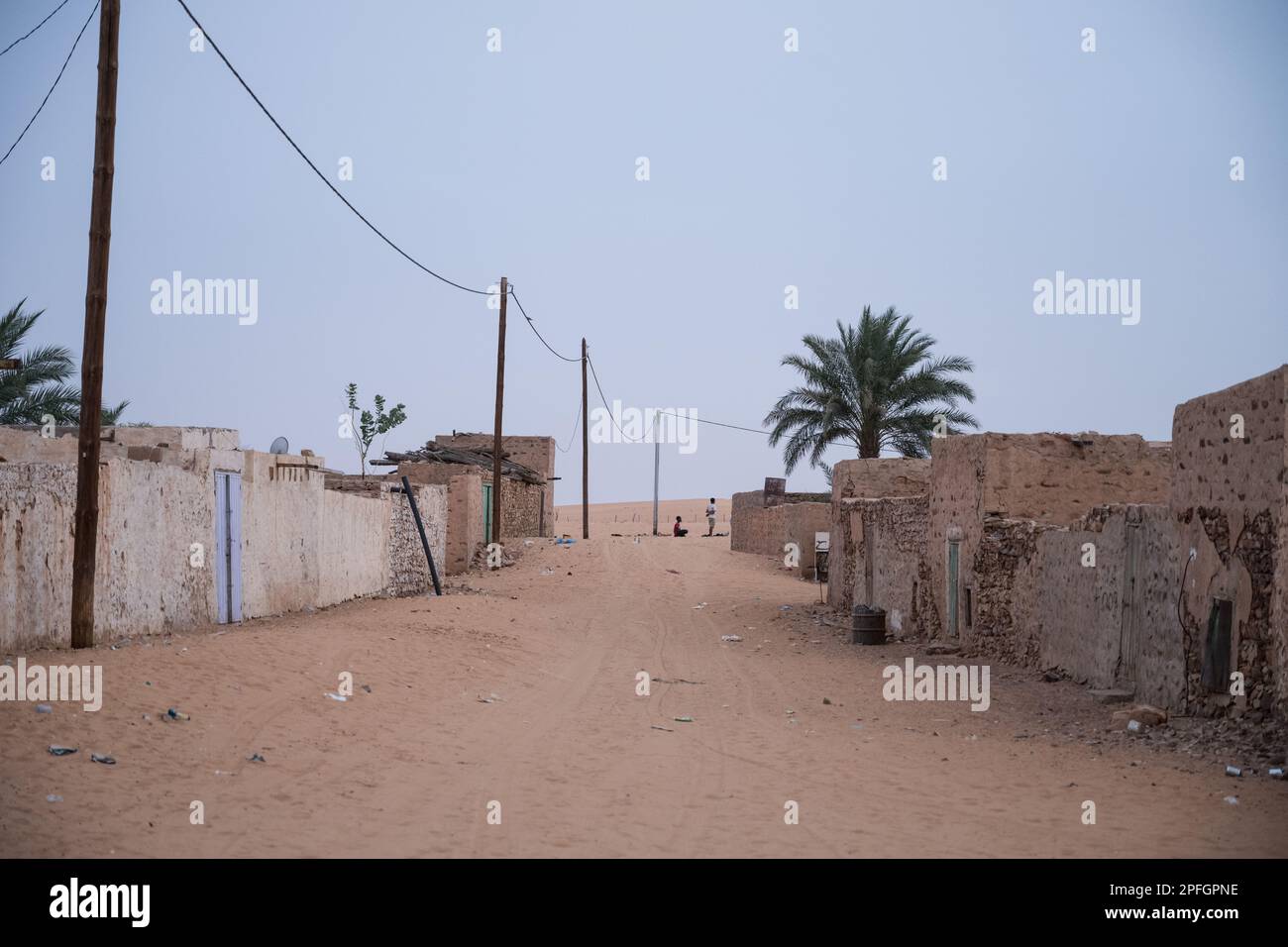 A narrow street in the ancient city of Chinguetti, Mauritania, lined ...