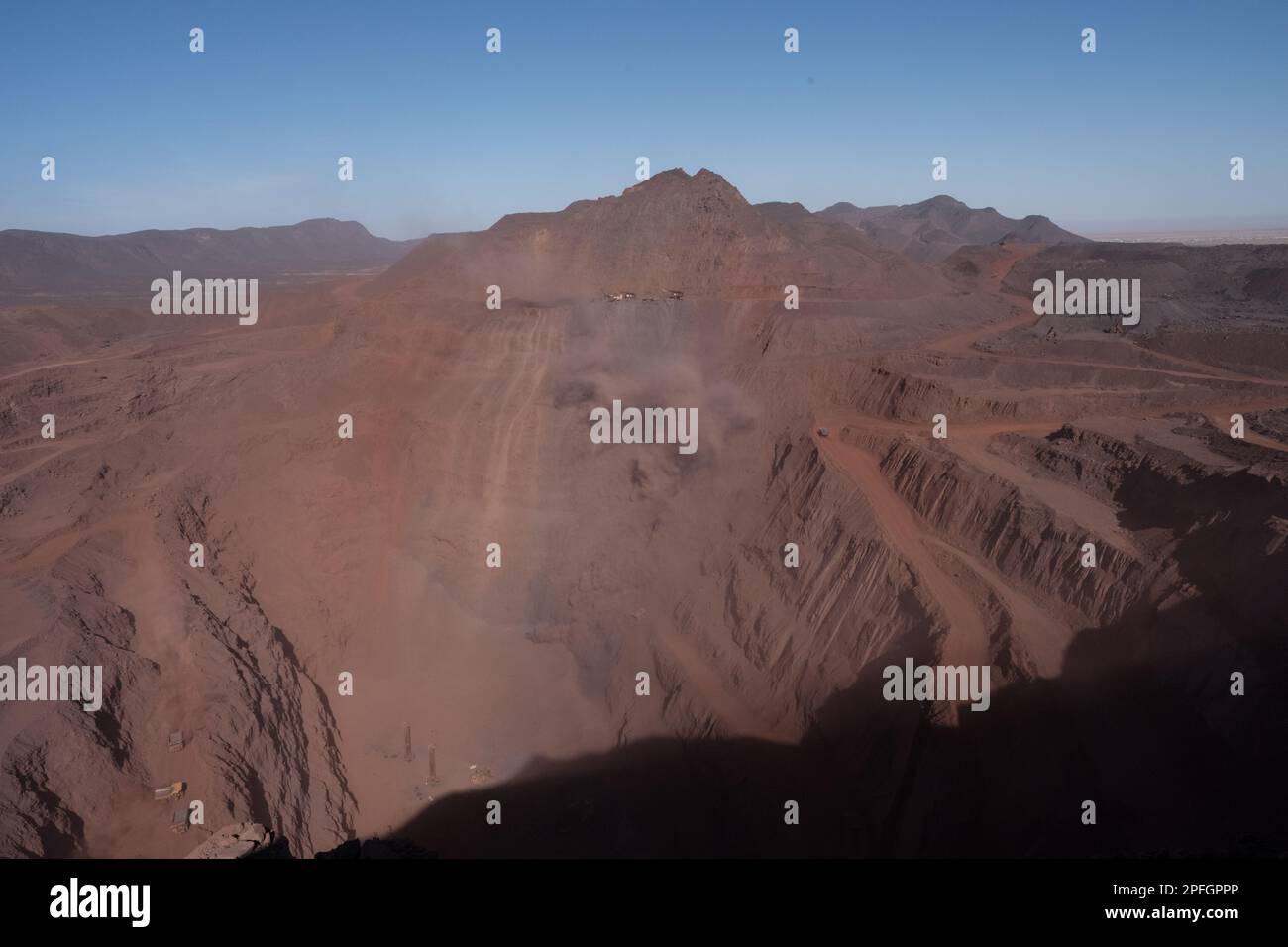 Trucks loading iron ore at the SNIM open-pit iron ore mine. Zouerat ...
