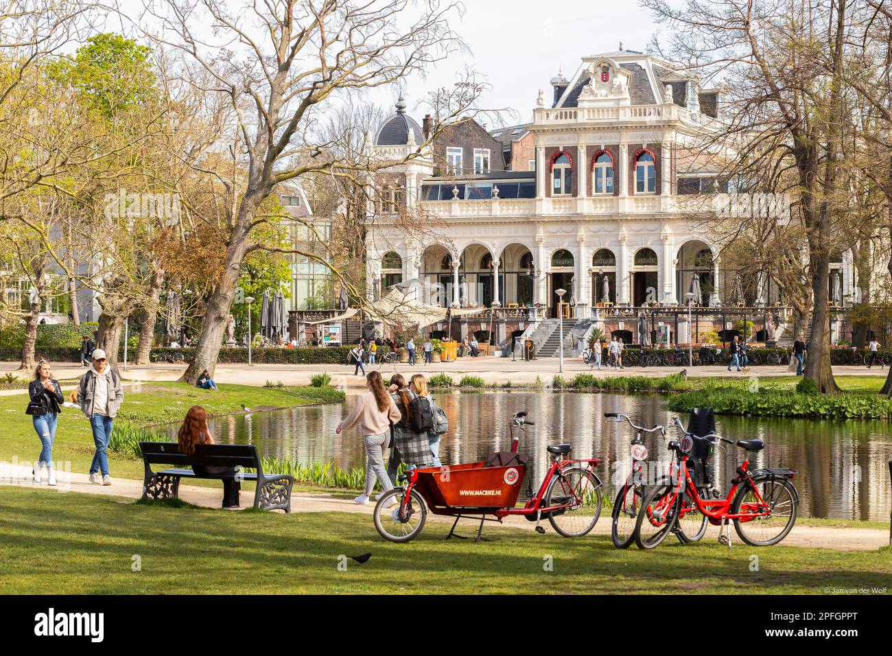 Tourists walk and cycle in the famous Vondelpark with the Vondelpark ...