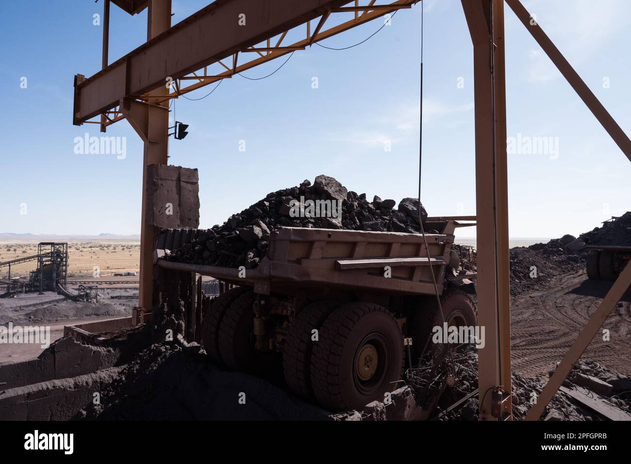 Trucks loading iron ore at the SNIM open-pit iron ore mine. Zouerat ...