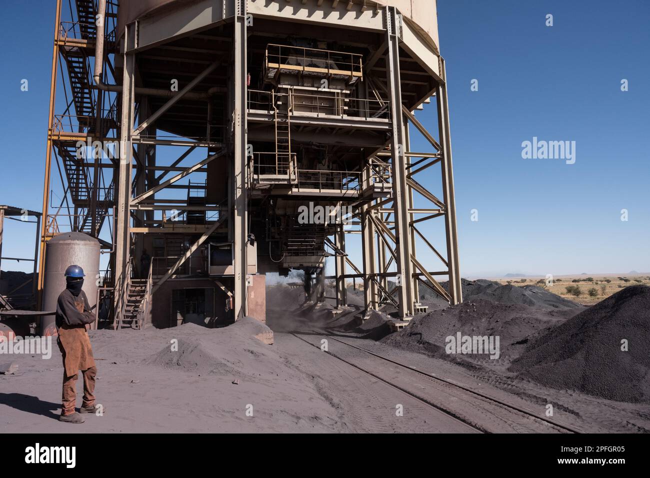 Miner, waiting to load the iron ore train at the SNIM open-pit iron ore ...
