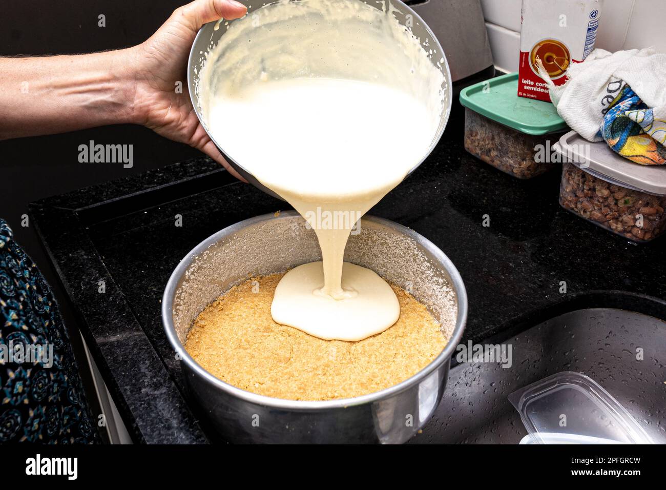 Chef woman mixing the ingredients to prepare the cheesecake. Plastic ...
