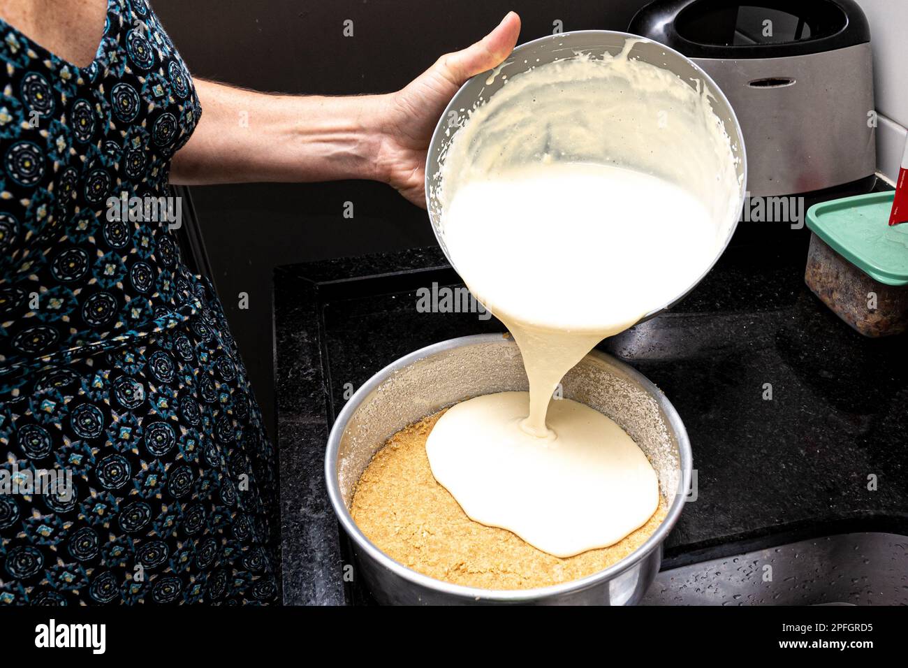 Chef woman mixing the ingredients to prepare the cheesecake. Plastic ...