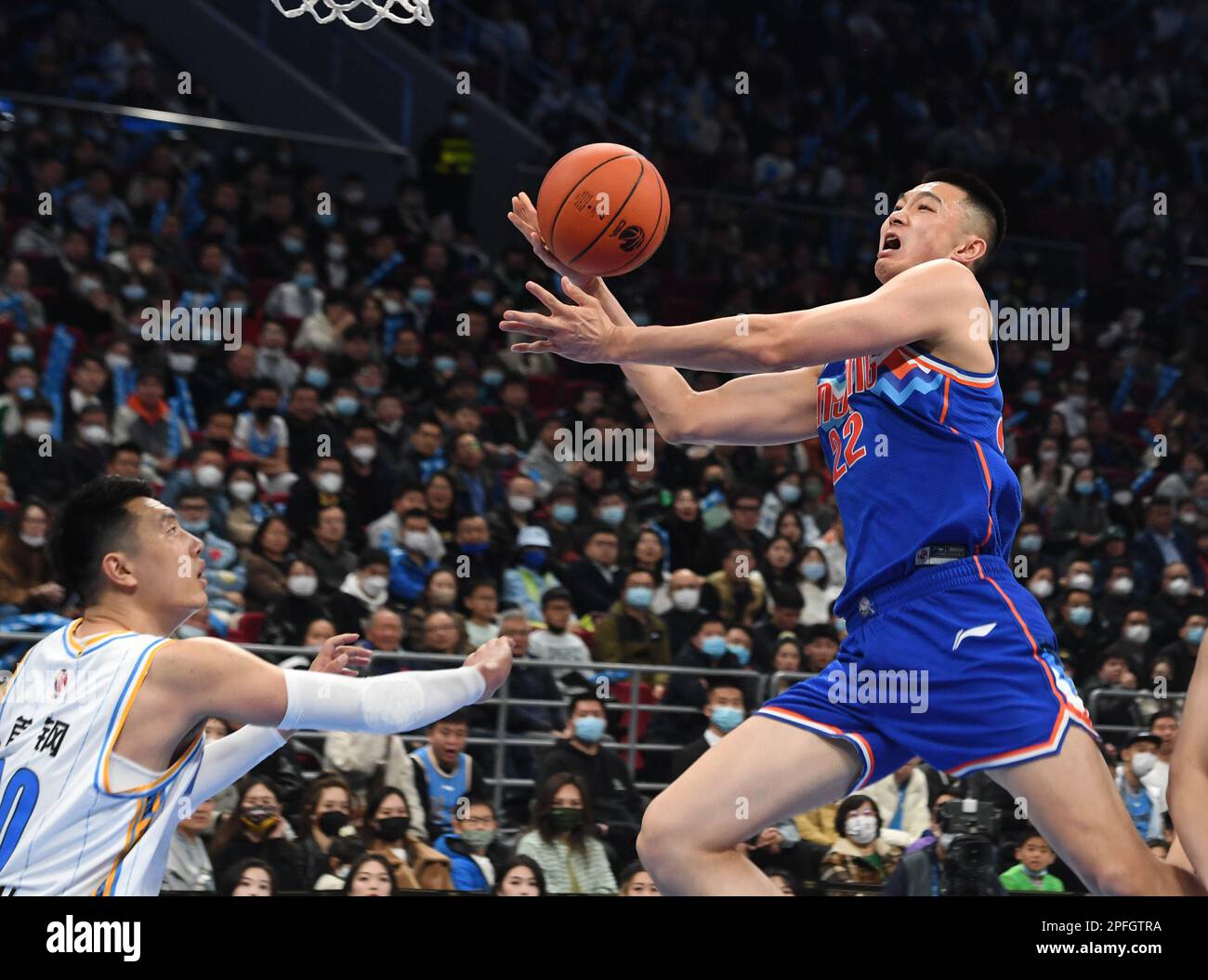 Beijing, China. 17th Mar, 2023. Zhu Xuhang (R) of Xinjiang Flying ...