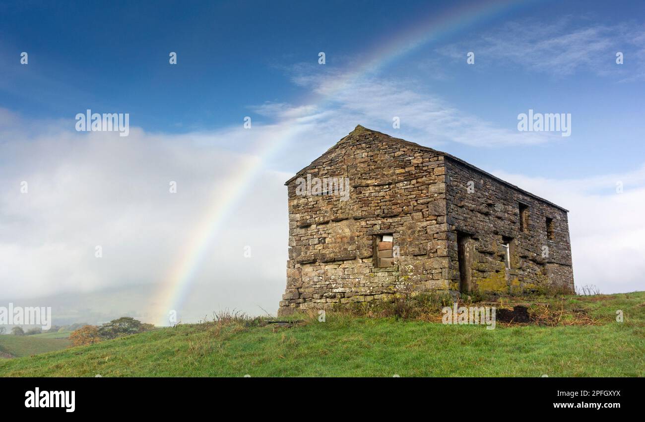 Rainbow over an old stone barn in the Yorkshire Dales, North Yorkshire ...