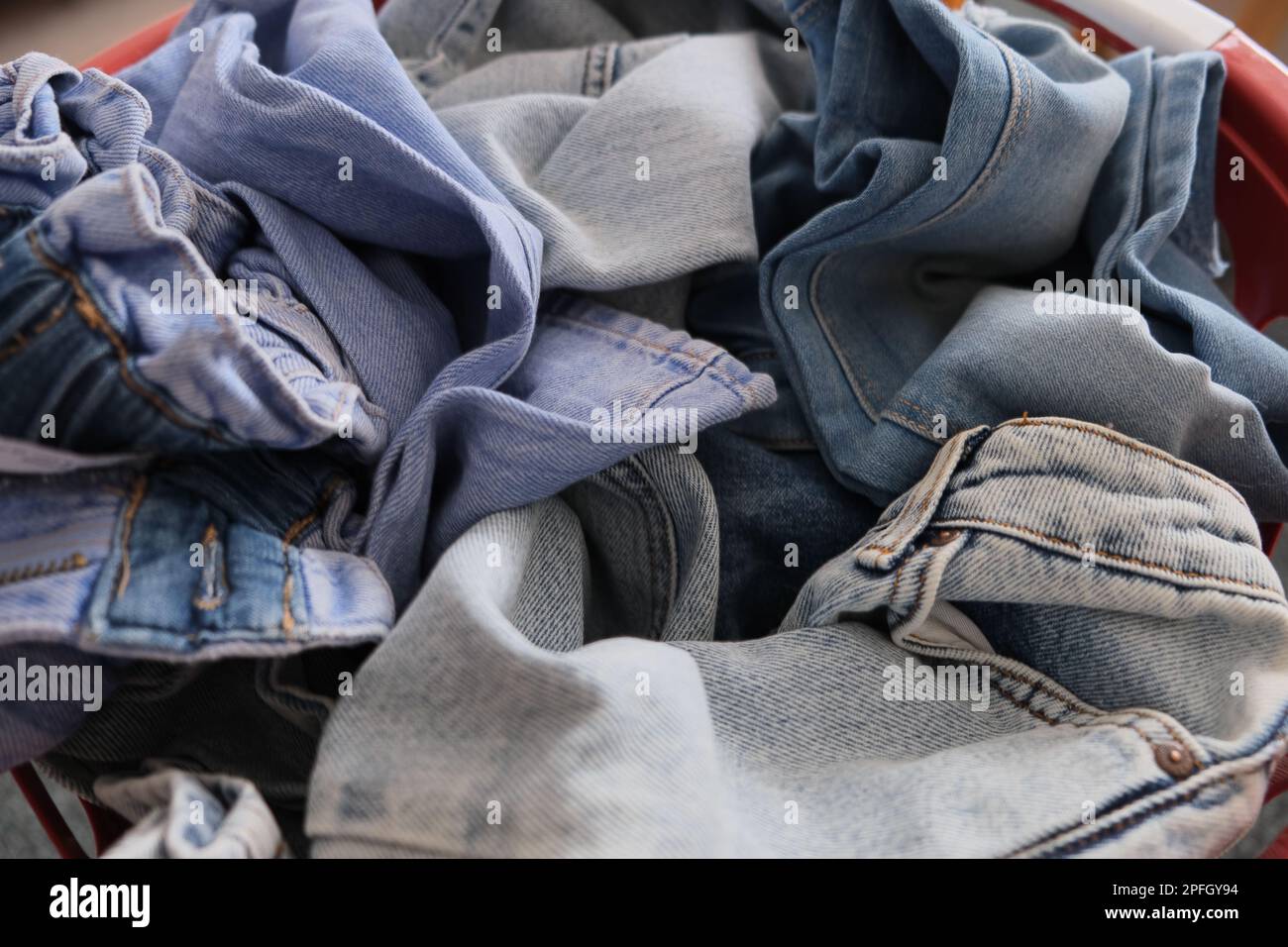 Pile of denim jeans pants, pile of denim jeans trousers being ...