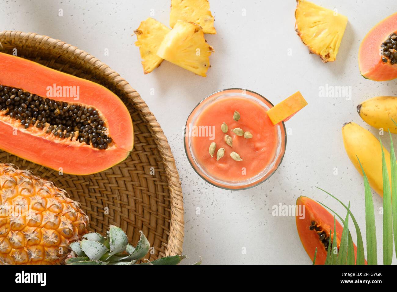 Summer tropical freshness Papaya smoothie or lassi on white background ...