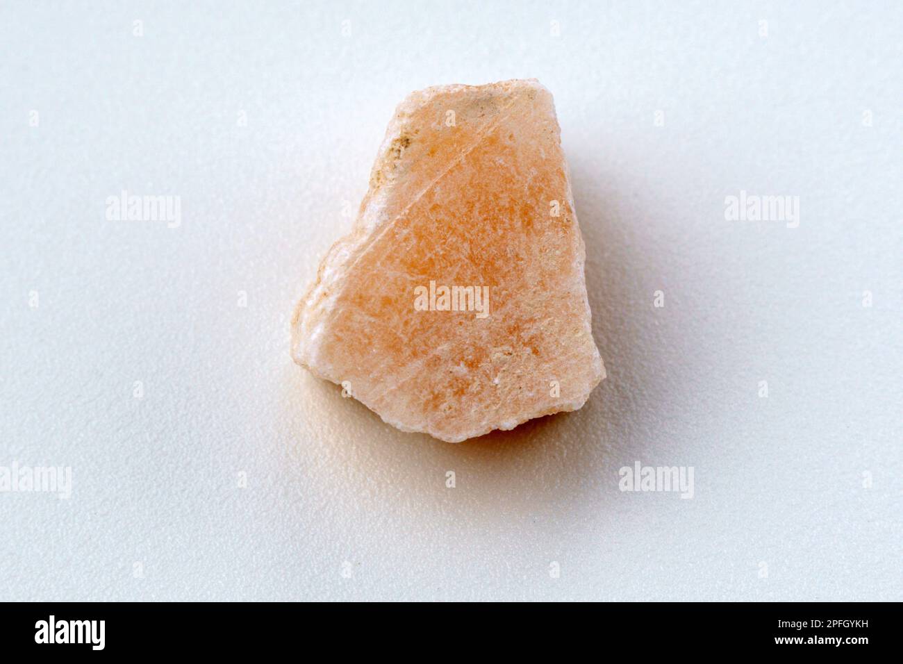 An unworked fragment of red gypsum, white background Stock Photo - Alamy