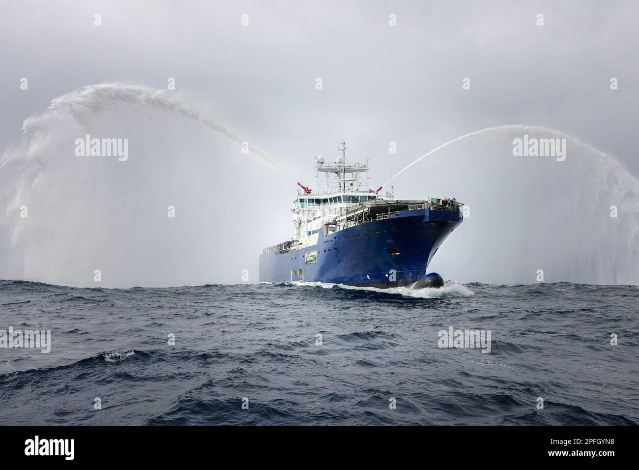 Tugboat demonstrating water discharge. A Rescue fireboat casting water ...