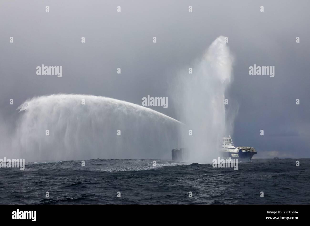Tugboat demonstrating water discharge. A Rescue fireboat casting water ...
