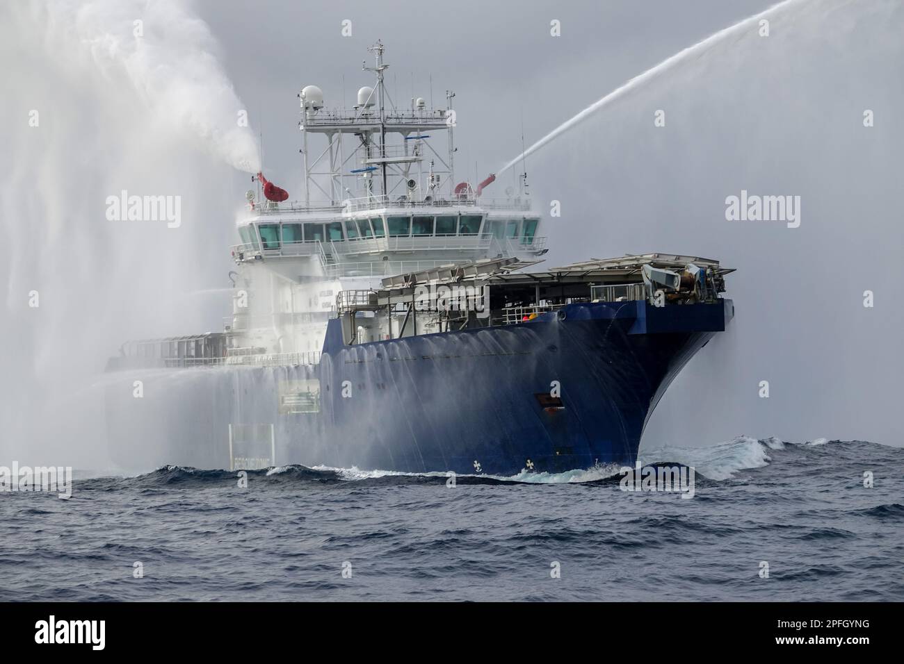 Tugboat demonstrating water discharge. A Rescue fireboat casting water ...