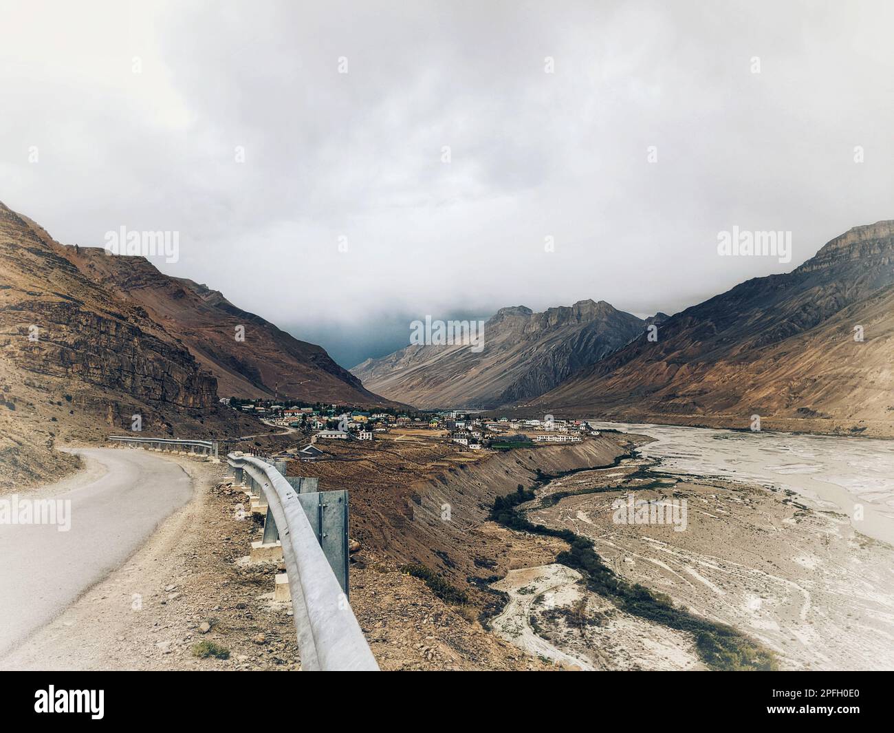 A scenic view of a winding road leading up the rolling hills, with a ...