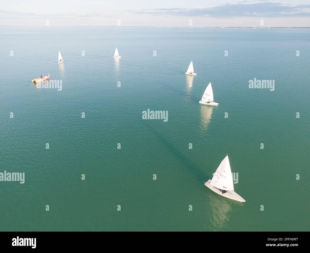 An aerial view of sailboats floating on the sparkling blue ocean Stock ...