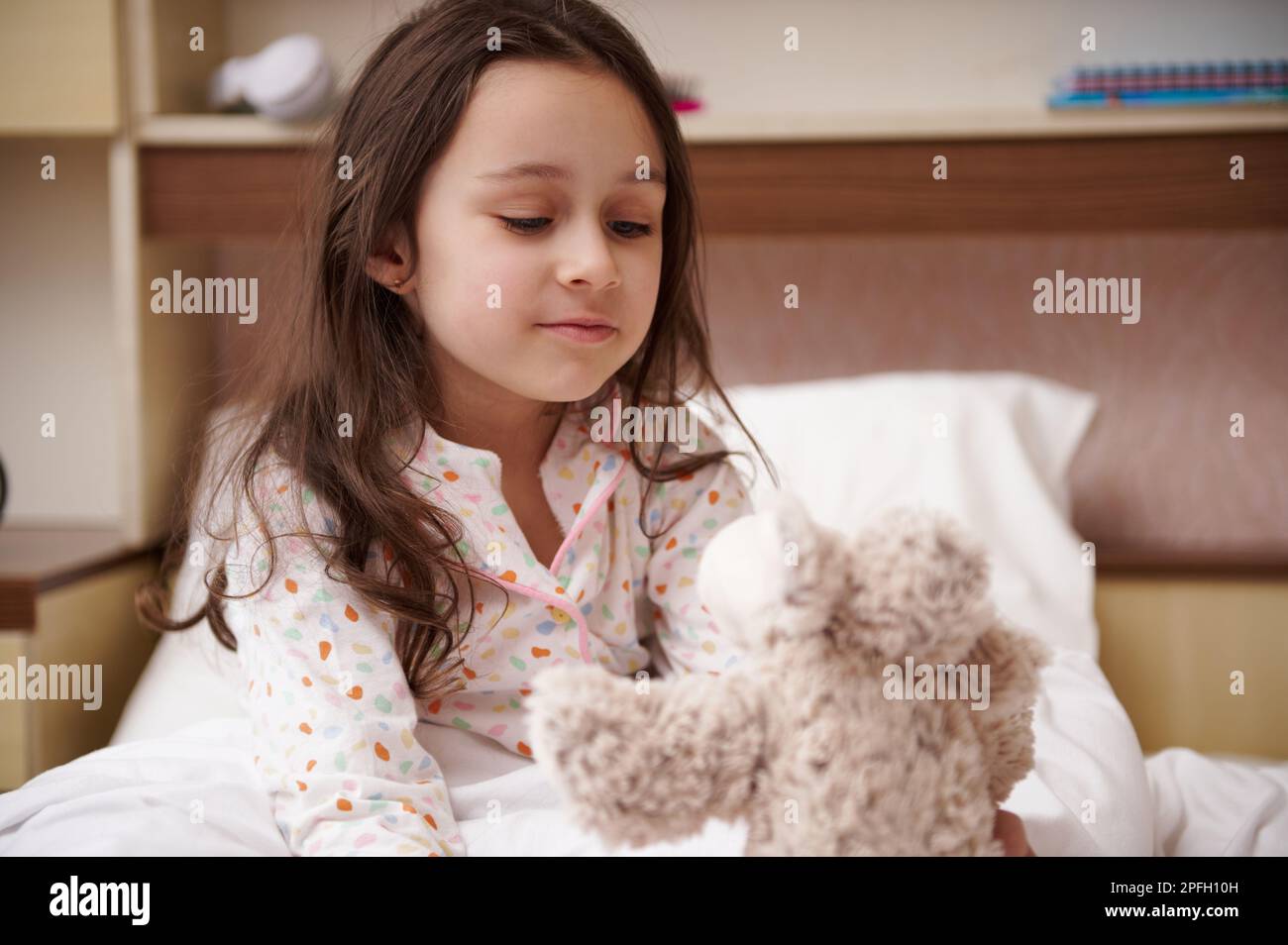 Lovely little child girl waking up in the morning and playing with her ...