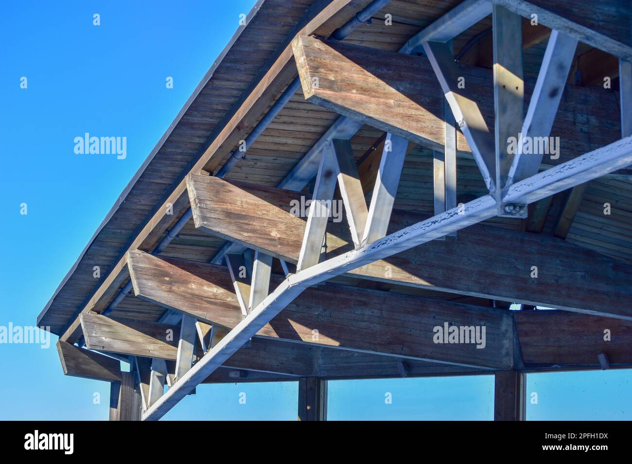 Standard timber framed building with close up on the roof trusses ...