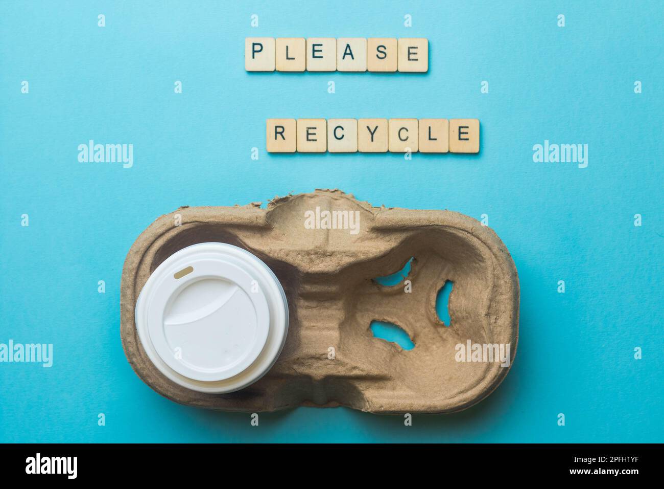 A carboard tray with a Coffee Cup and a sign reading please recycle ...