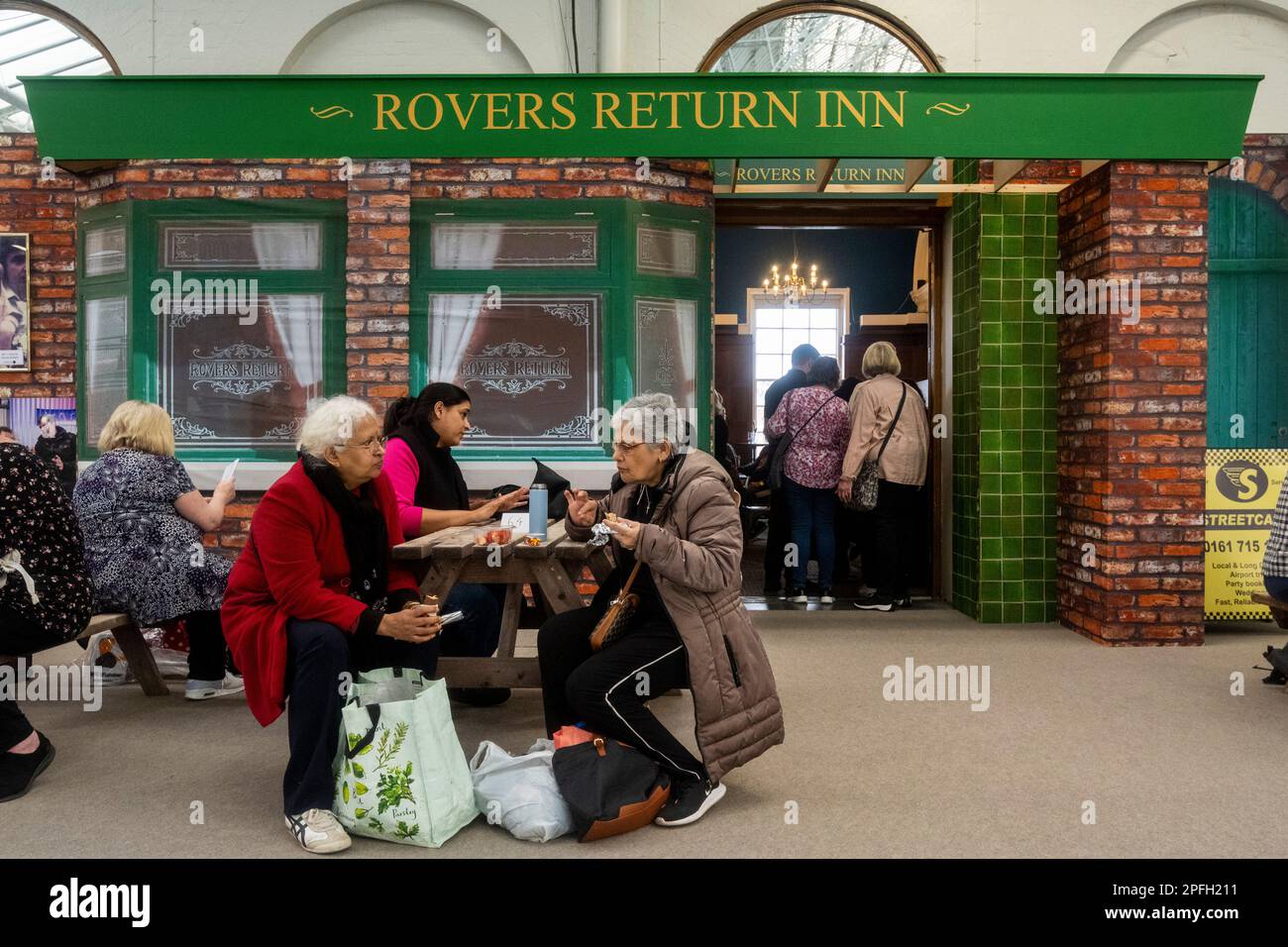 London, UK. 17 March 2023. Visitors take a break at a mock-up of ...