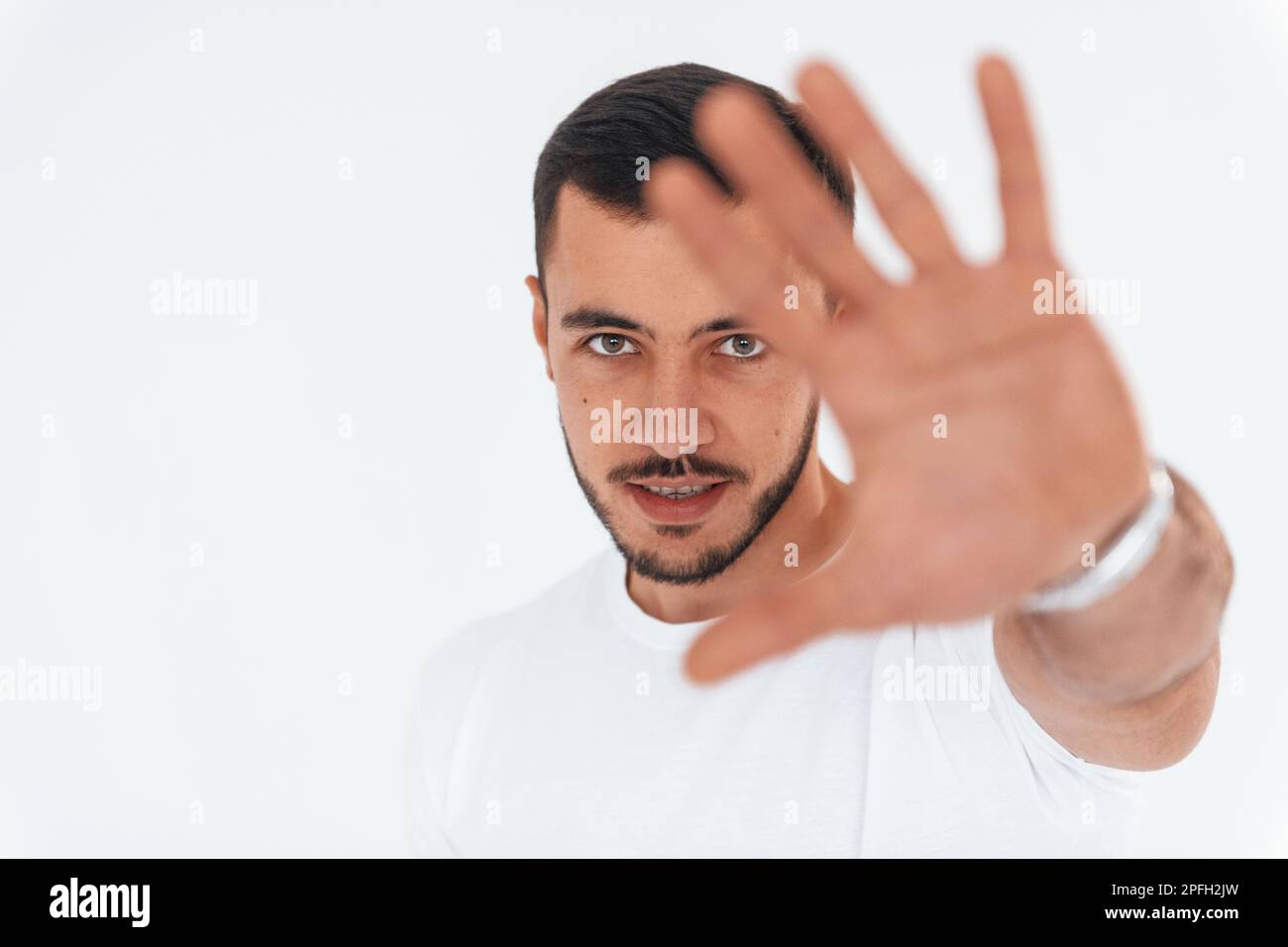 Stop Gesture Young Handsome Man Standing Indoors Against White