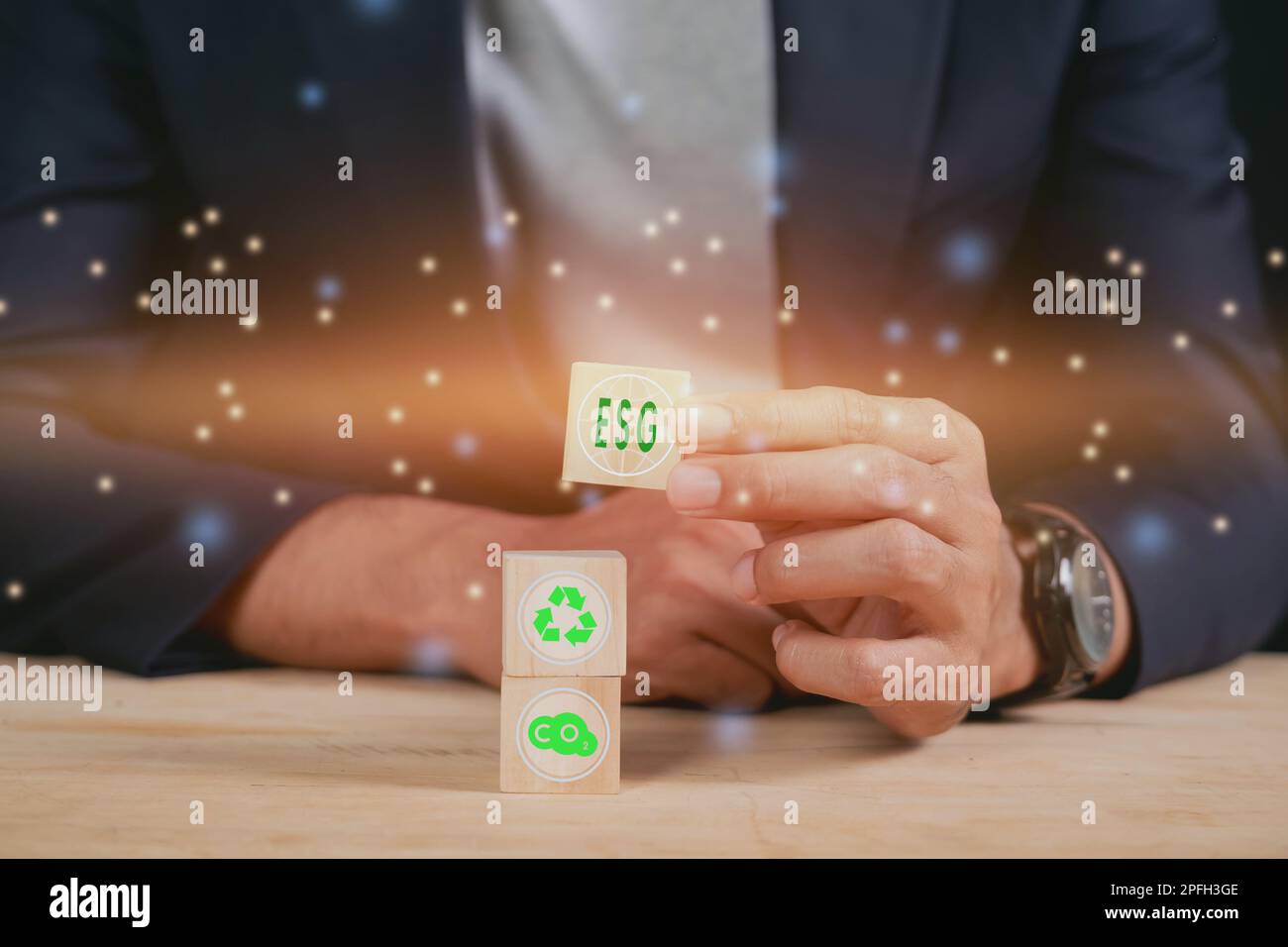Businessman lifting ESG wooden cubes on the table. Environmental ESG ...