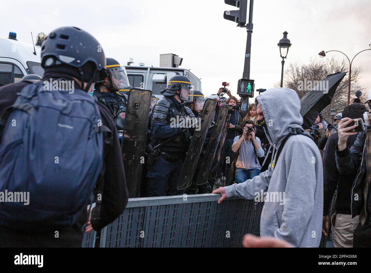 Paris, France 16th Mar, 2023. Protesters face a squad of police during ...