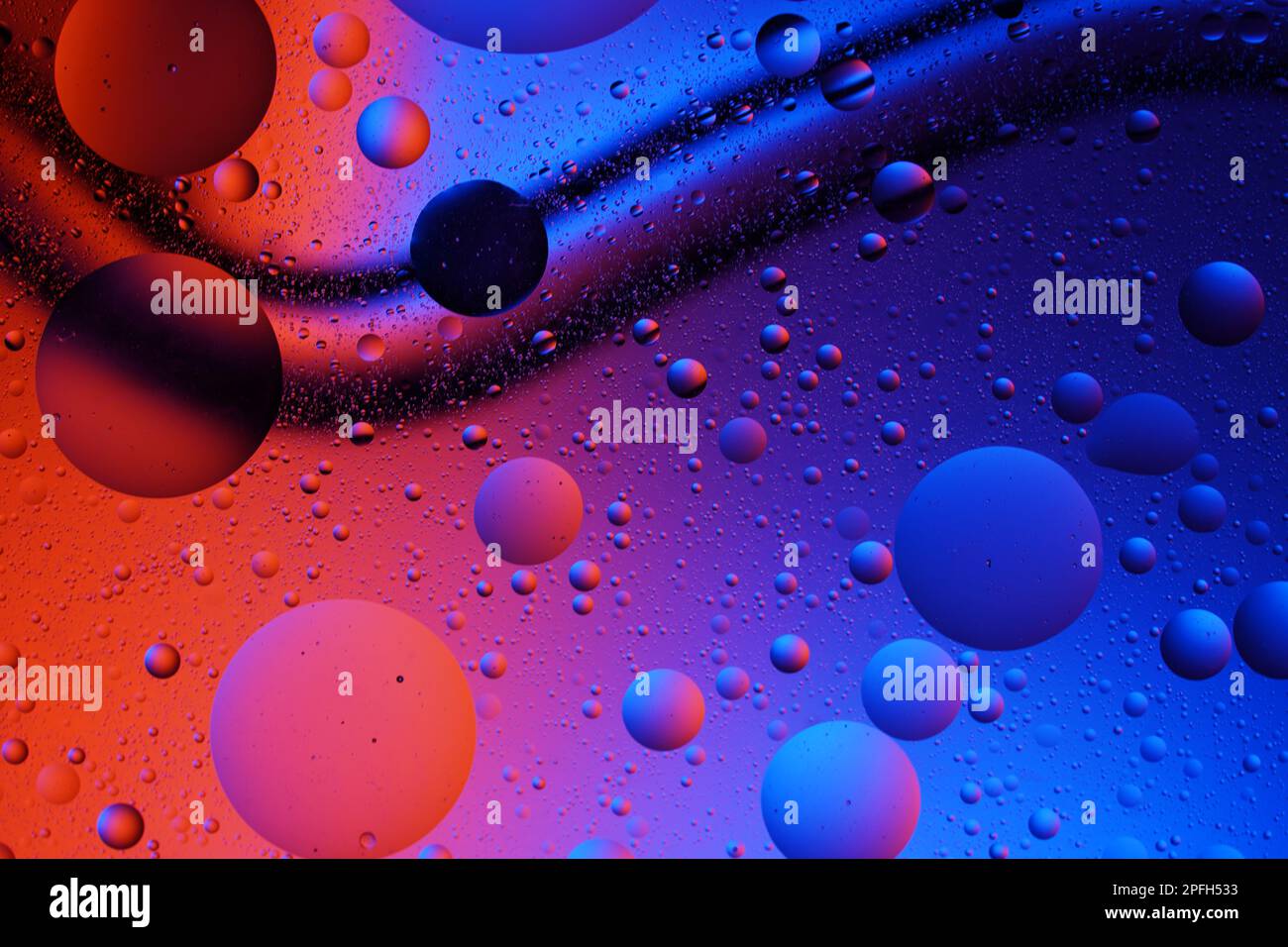 Amazing oil drop in the water. Colour effect Stock Photo - Alamy