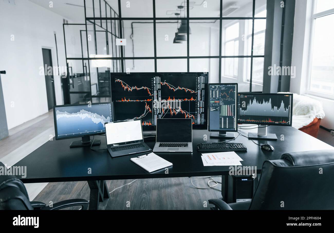 Interior of modern office with many of computer screens with stock ...